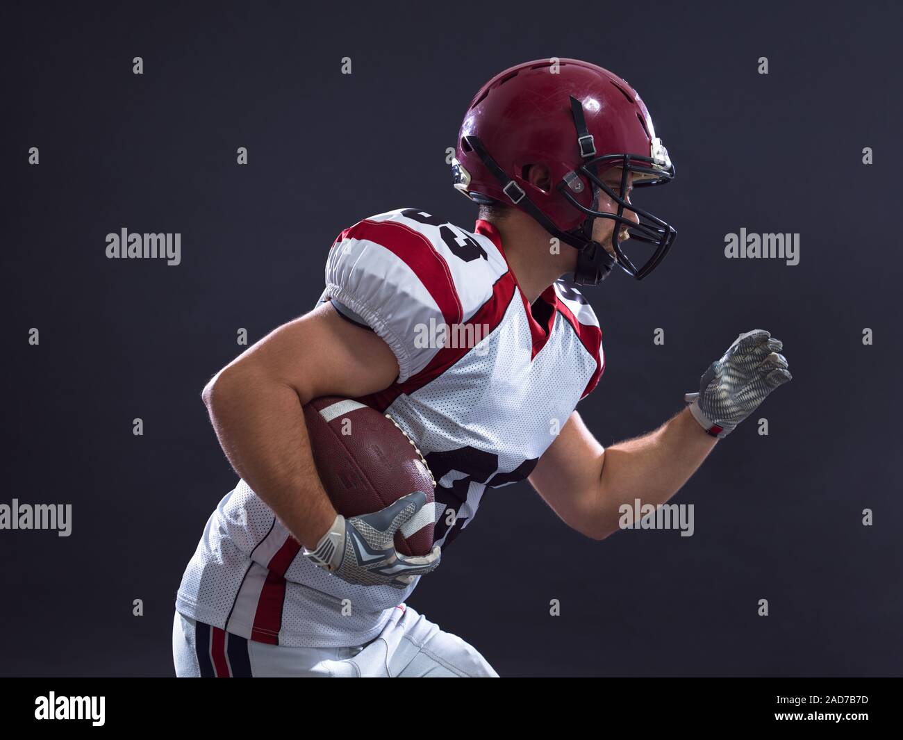 American football Player running with the ball Stock Photo - Alamy