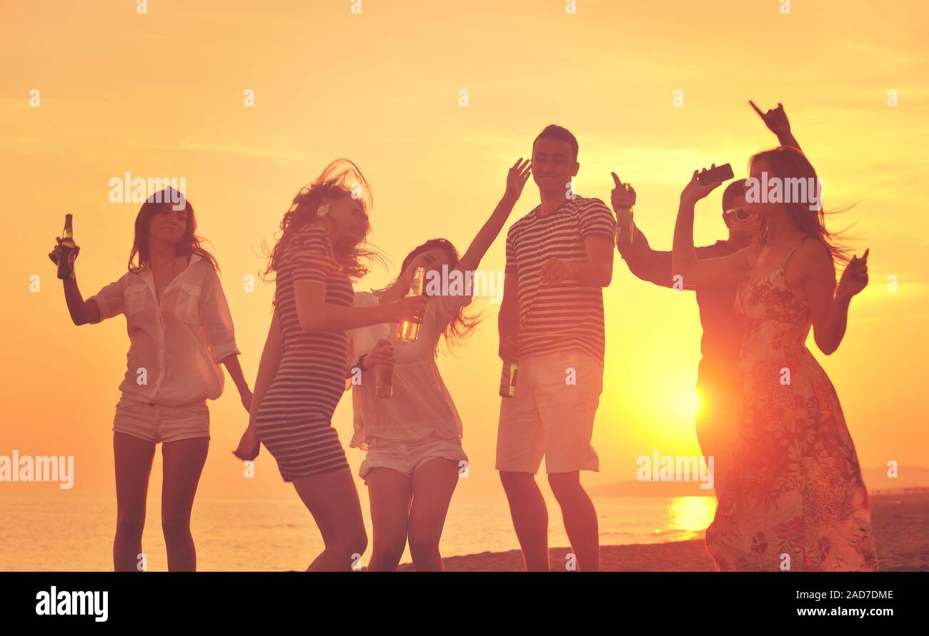 Group of young people enjoy summer party at the beach Stock Photo - Alamy