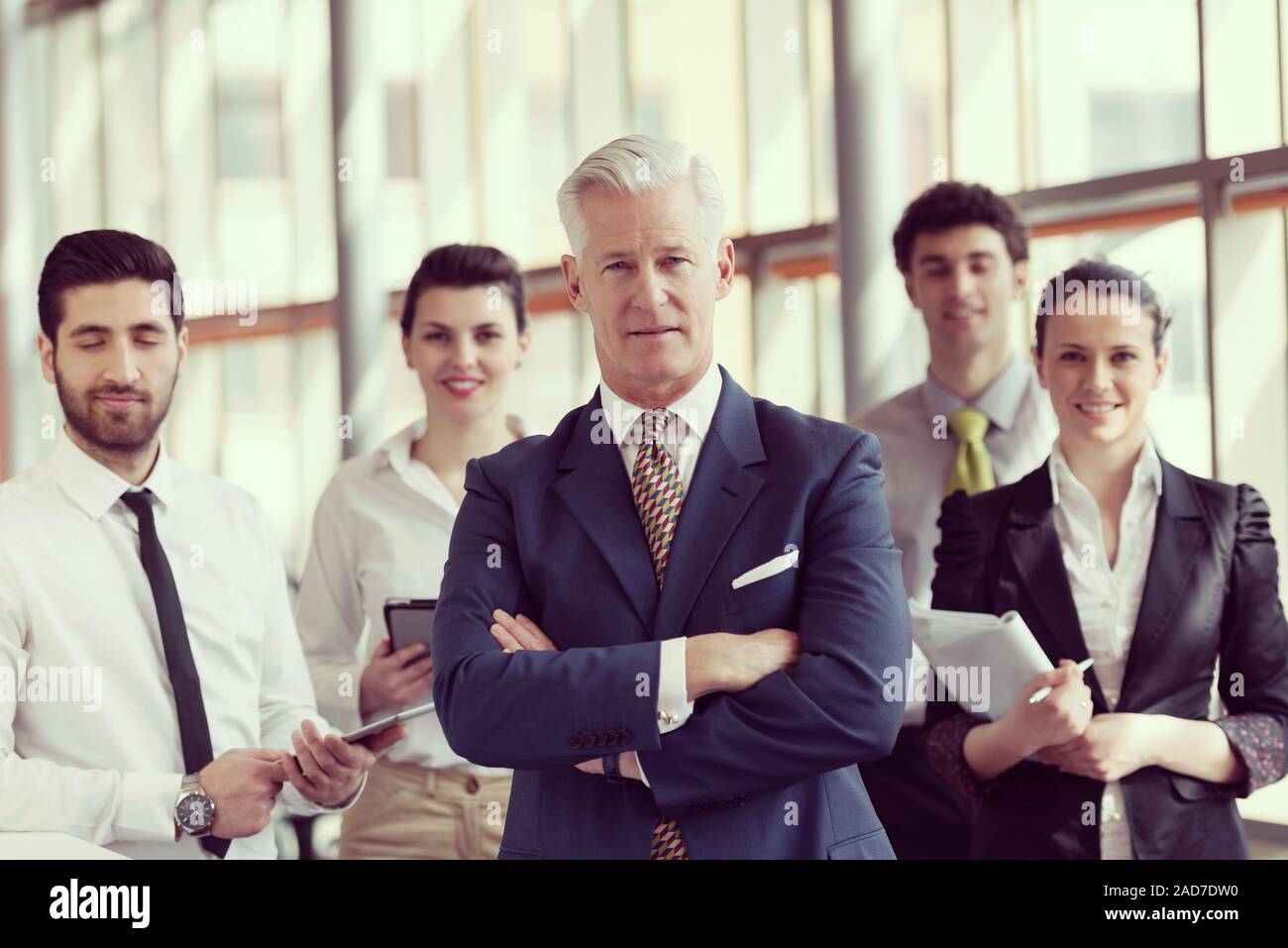 portrait of senior Businessman as leader with group of people in ...
