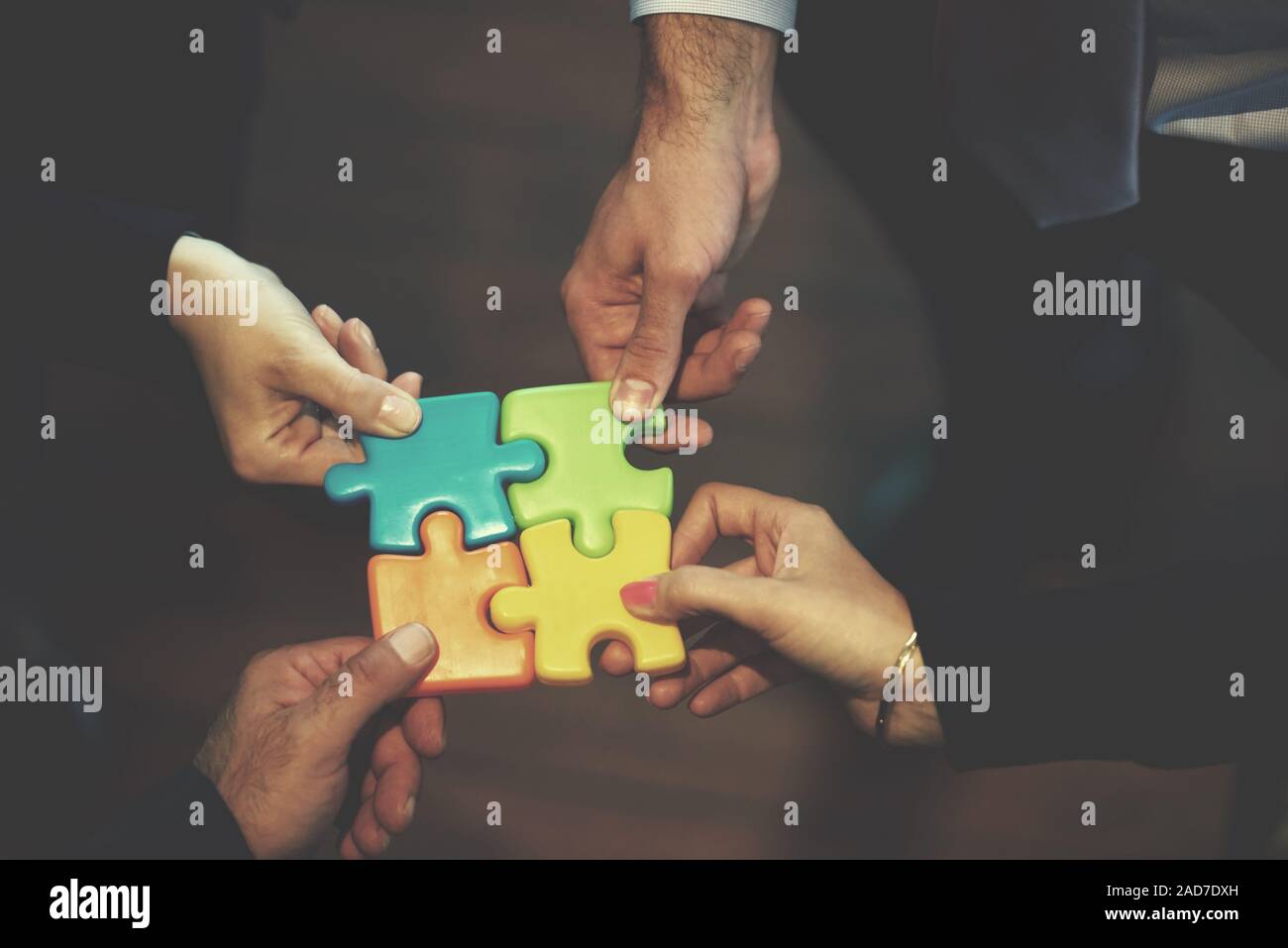 assembling jigsaw puzzle Stock Photo - Alamy