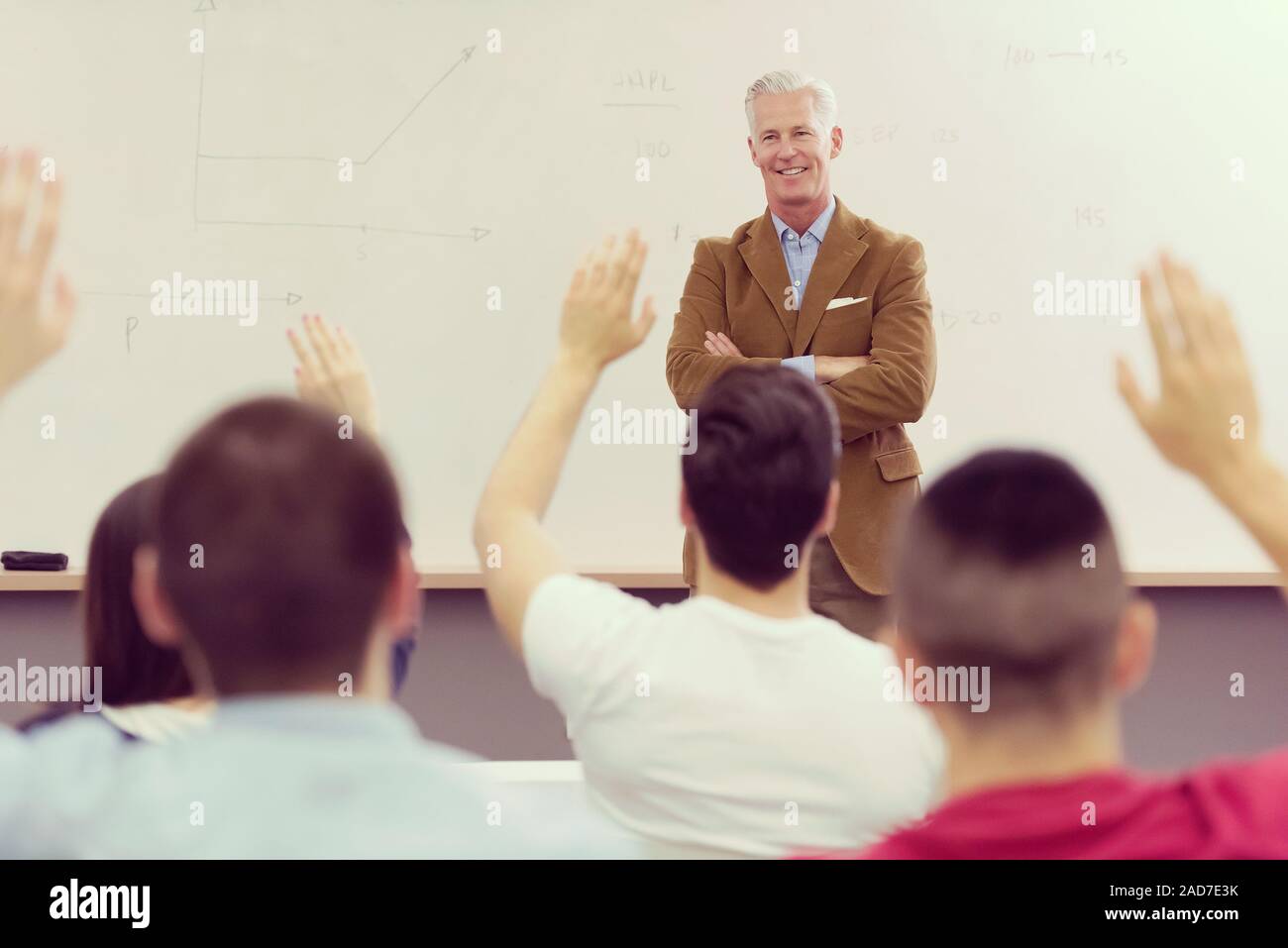 teacher with a group of students in classroom Stock Photo - Alamy
