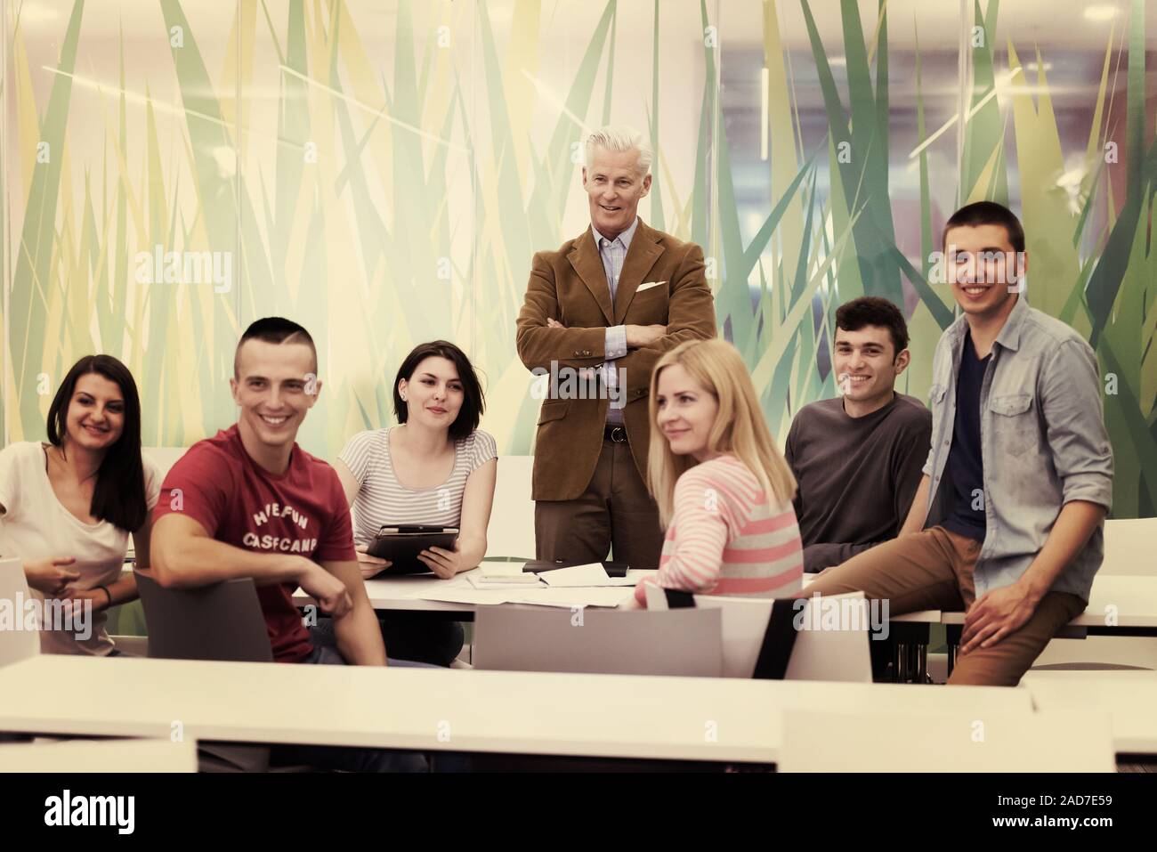 portrait of teacher with students group in background Stock Photo - Alamy