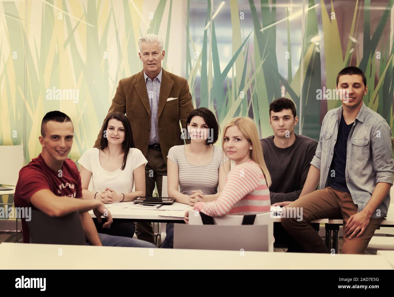 portrait of teacher with students group in background Stock Photo - Alamy
