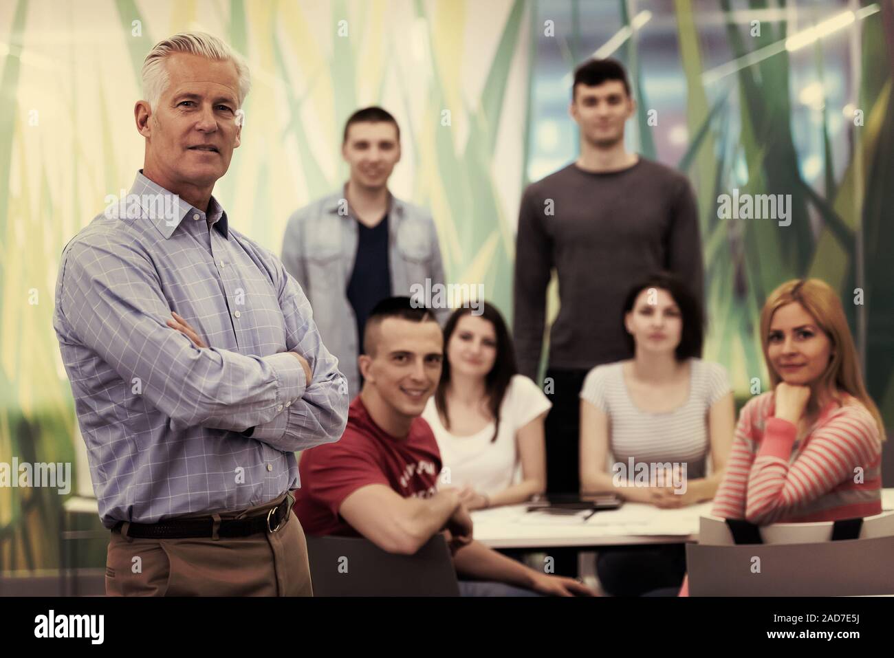 portrait of teacher with students group in background Stock Photo - Alamy