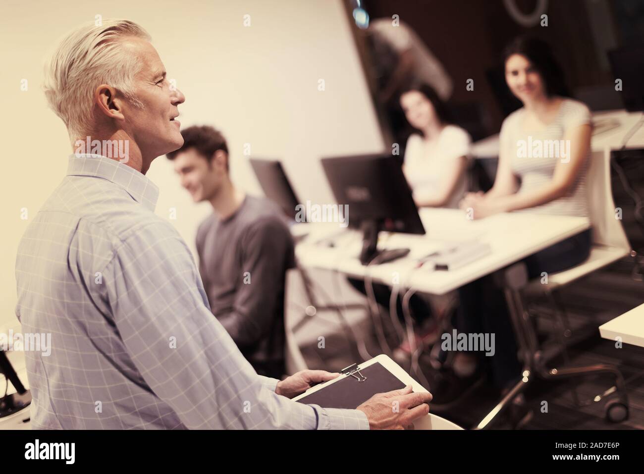 teacher and students in computer lab classroom Stock Photo - Alamy