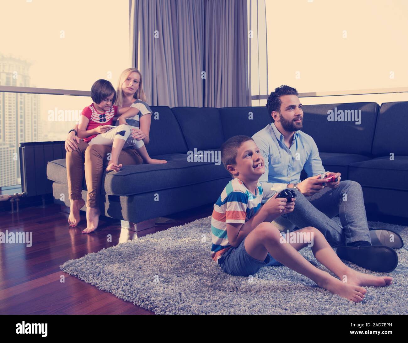 Happy family playing a video game Stock Photo - Alamy