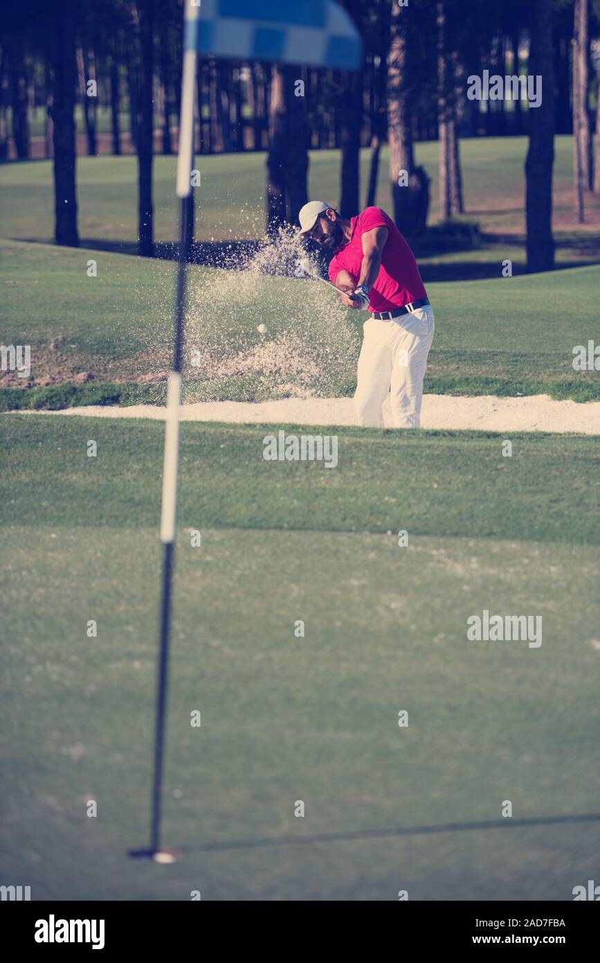 golfer hitting a sand bunker shot Stock Photo - Alamy