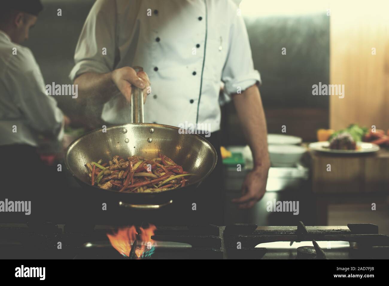 chef flipping vegetables in wok Stock Photo - Alamy