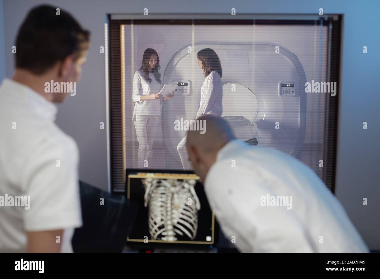 In Control Room Doctor and Radiologist Discuss Diagnosis while Watching ...