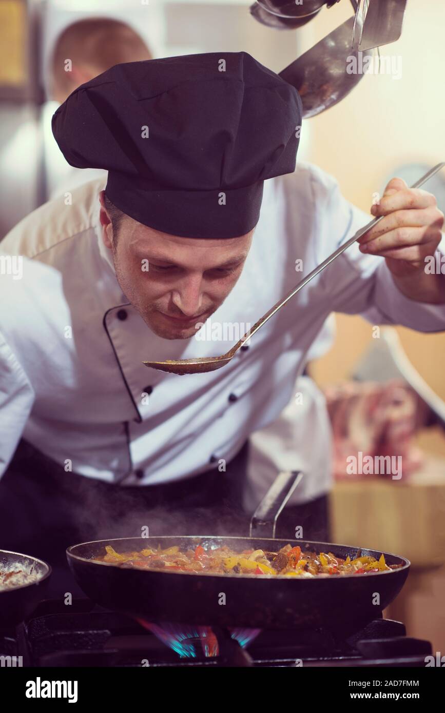 chef tasting food with spoon Stock Photo - Alamy