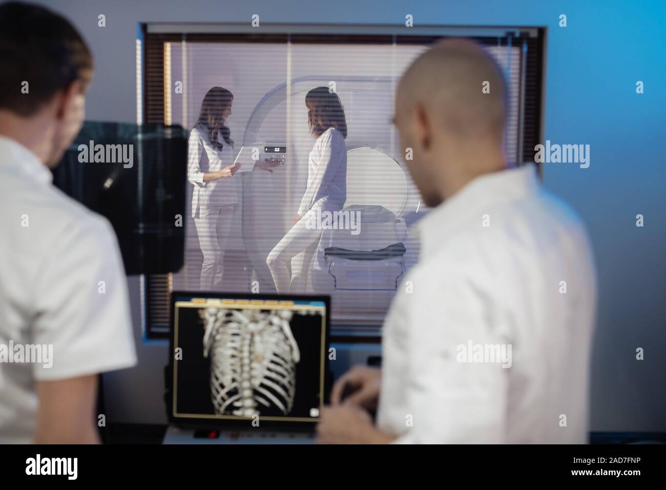 In Control Room Doctor and Radiologist Discuss Diagnosis while Watching ...