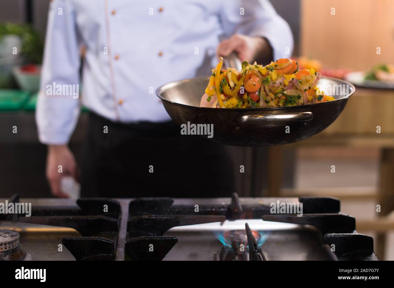 Professional male chef tossing vegetables hi-res stock photography and ...