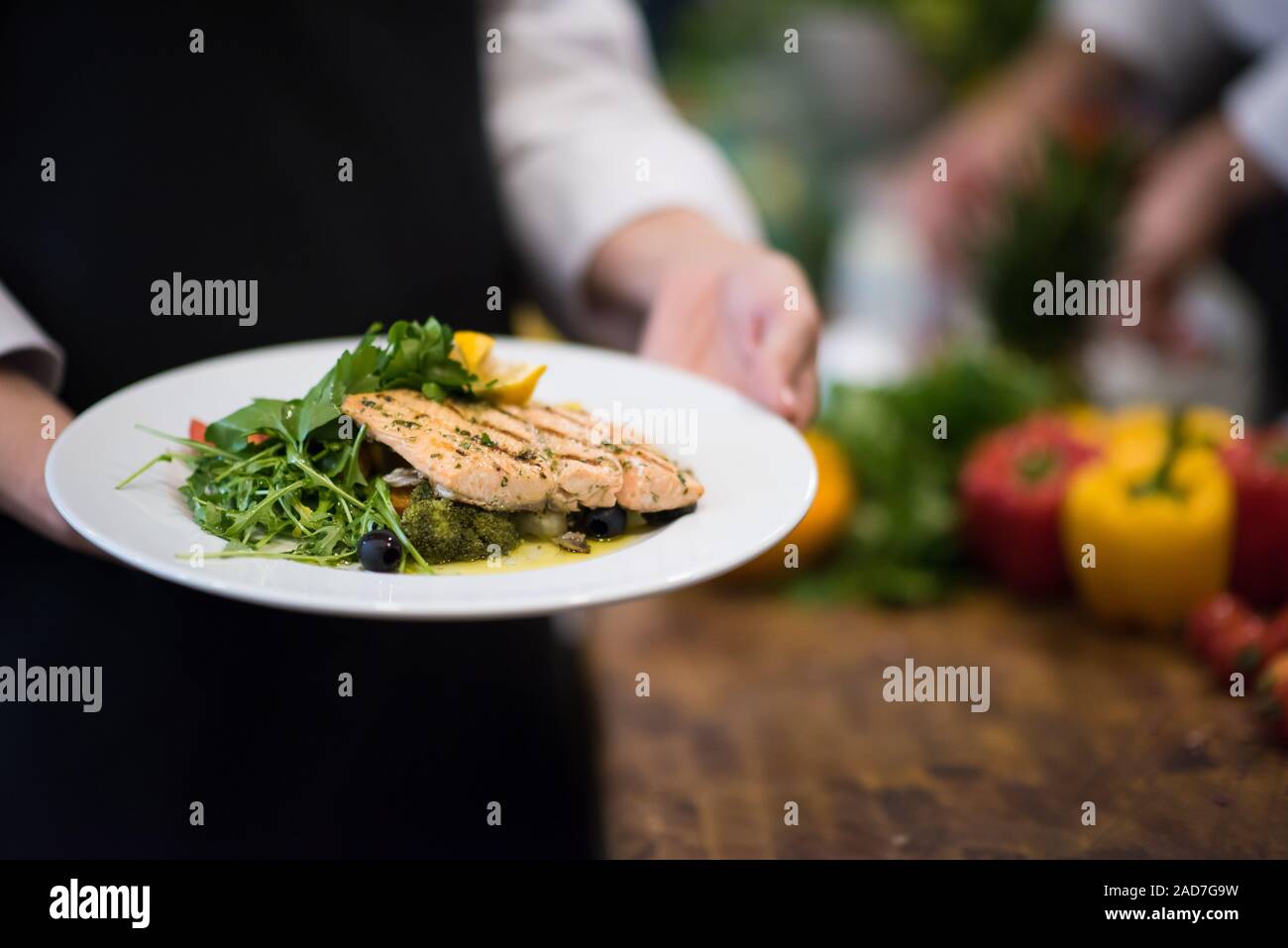 Chef hands holding dish of fried Salmon fish fillet Stock Photo - Alamy
