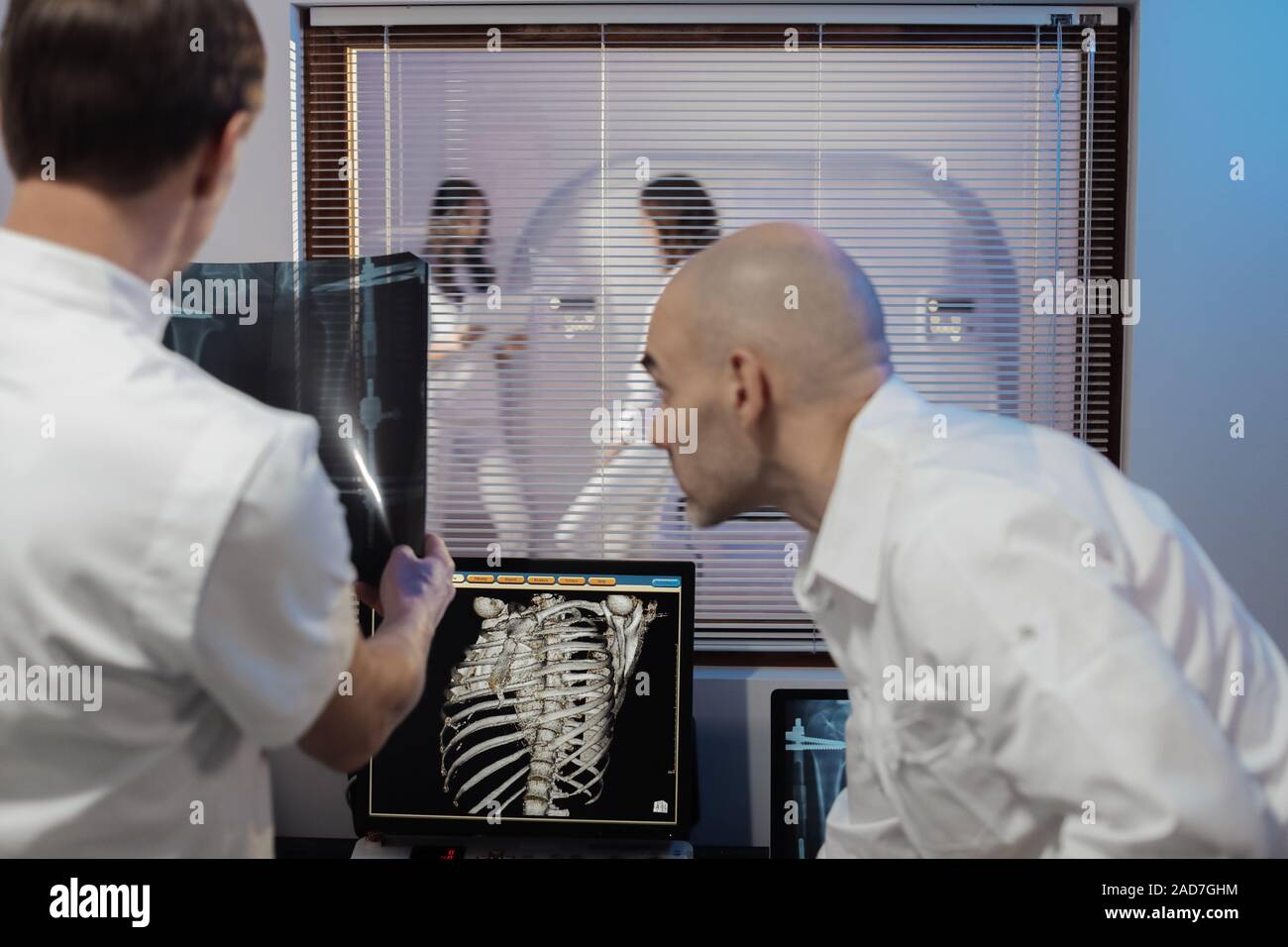 In Control Room Doctor and Radiologist Discuss Diagnosis while Watching ...