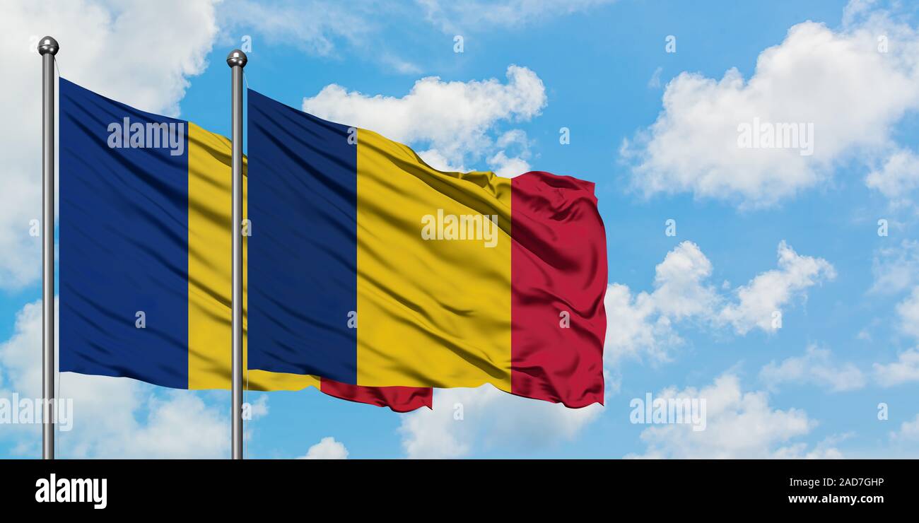 Romania and Chad flag waving in the wind against white cloudy blue sky ...