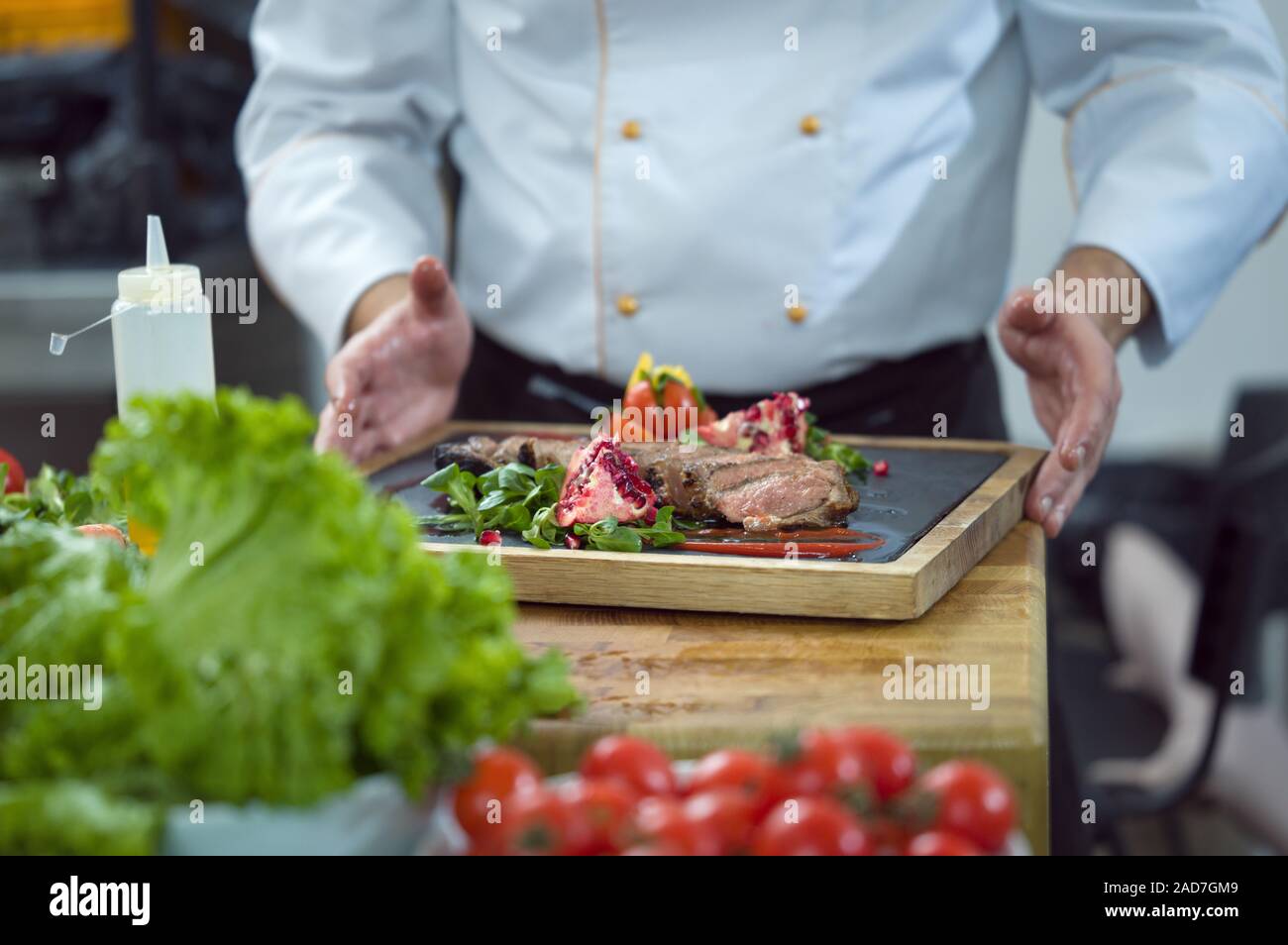 closeup of Chef hands serving beef steak Stock Photo - Alamy