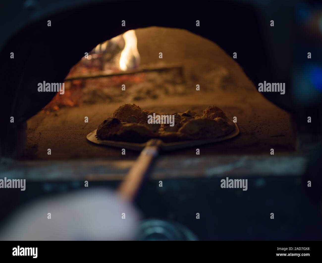 chef removing hot pizza from stove Stock Photo - Alamy