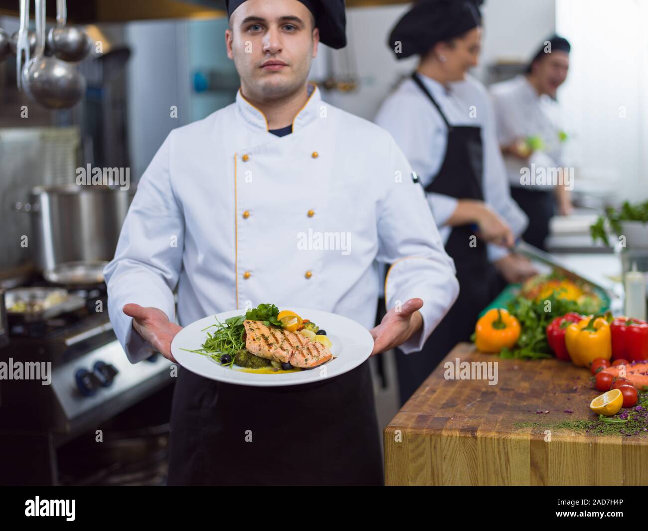 Chef holding dish of fried Salmon fish fillet Stock Photo - Alamy
