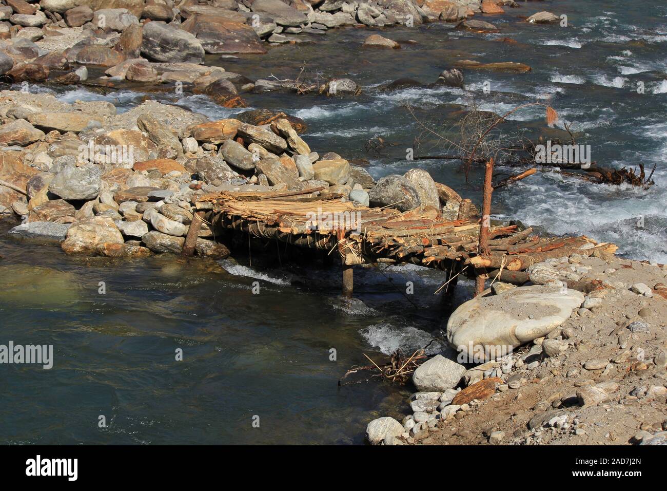 Simple timber bridge over Langtang Khola, river in Nepal. Scene near ...