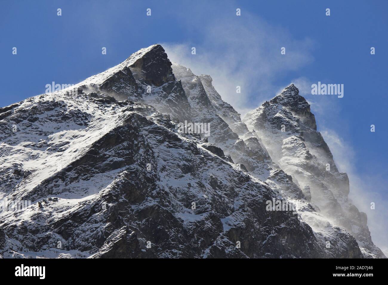 Strong winds blowing snow over mountain peaks in the Himalayas Stock ...