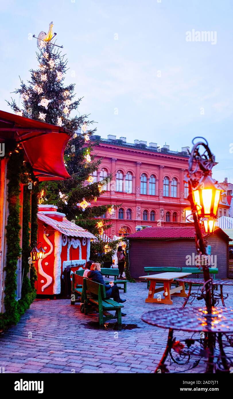 People and Christmas market in Dome square Riga reflex Stock Photo - Alamy