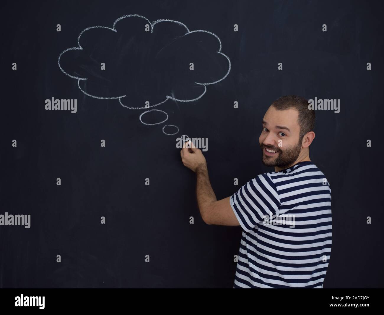 young future father thinking in front of black chalkboard Stock Photo ...