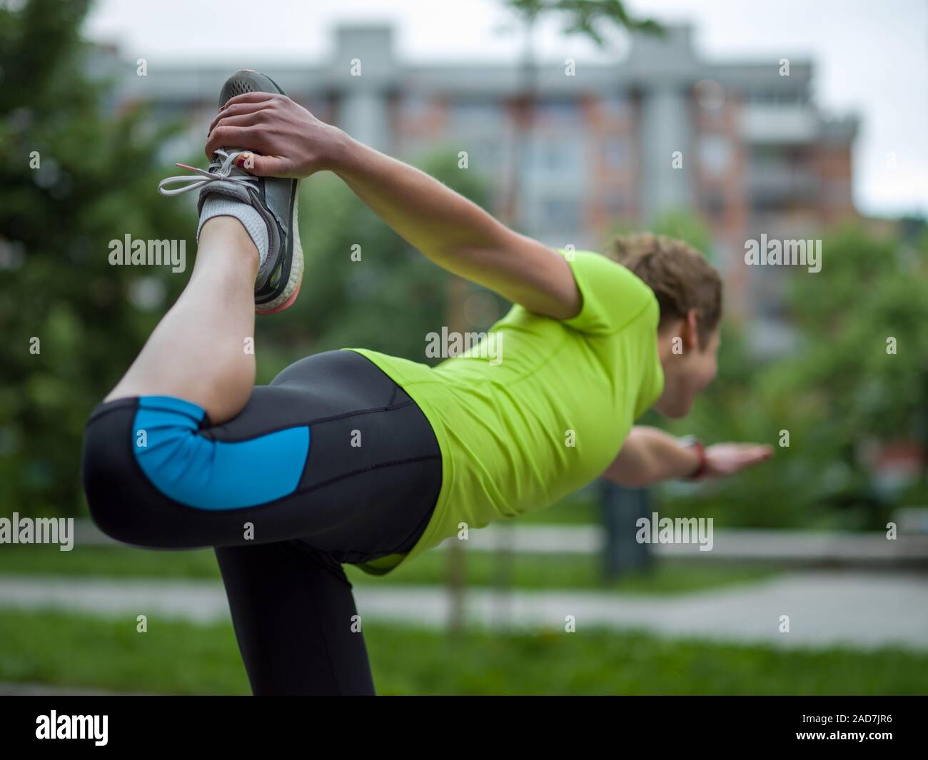 female runner warming up and stretching before morning training Stock ...