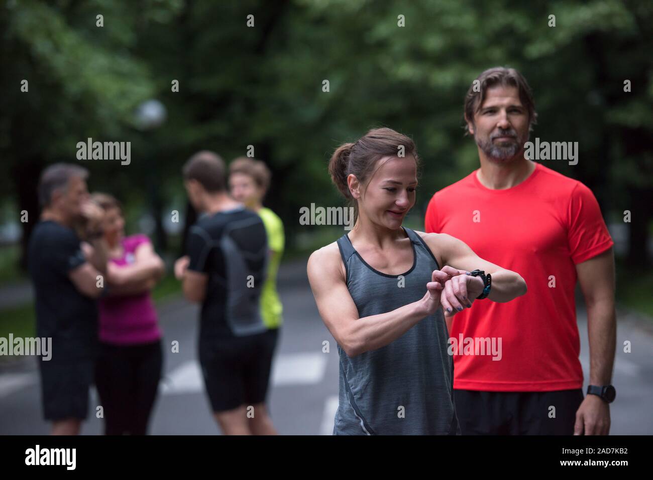 sporty couple using smart watches Stock Photo - Alamy