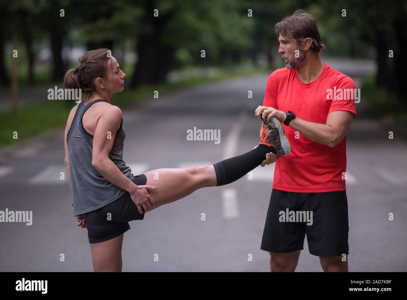 runners team warming up and stretching before morning training Stock ...
