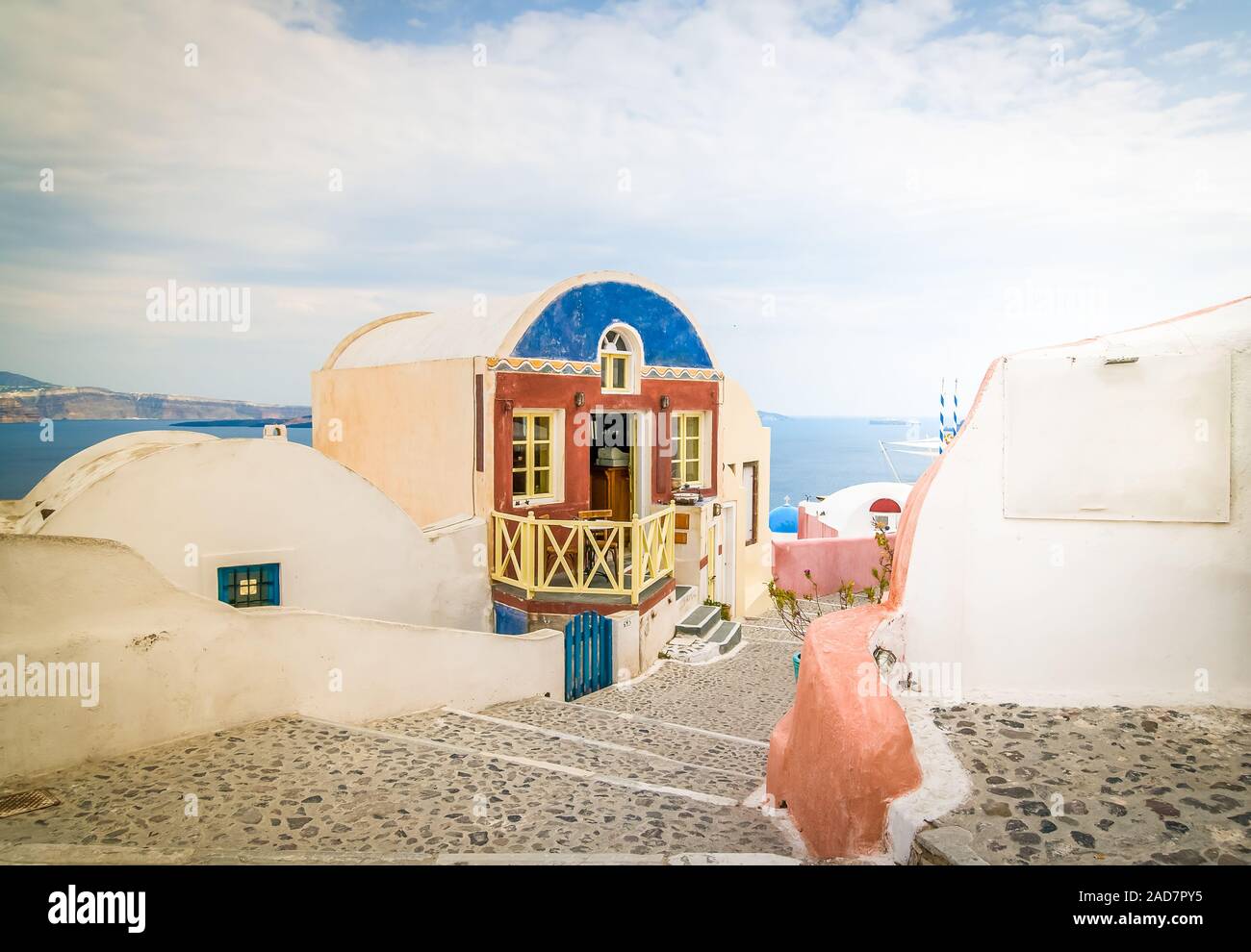 Typical colorful narrow street in Oia the most beautiful village of ...