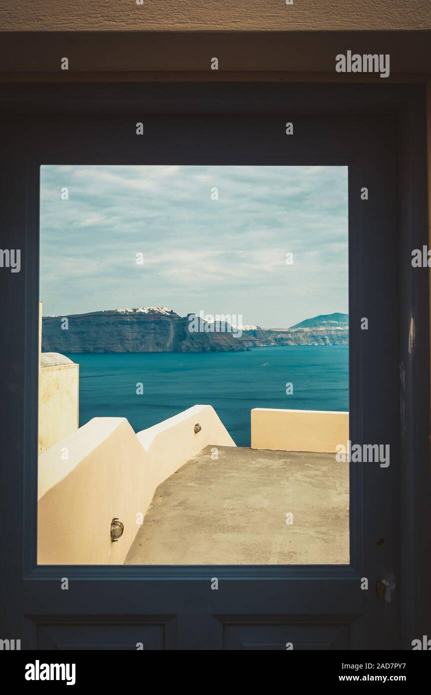 Window with view of Thira and caldera of Santorini volcano Stock Photo ...