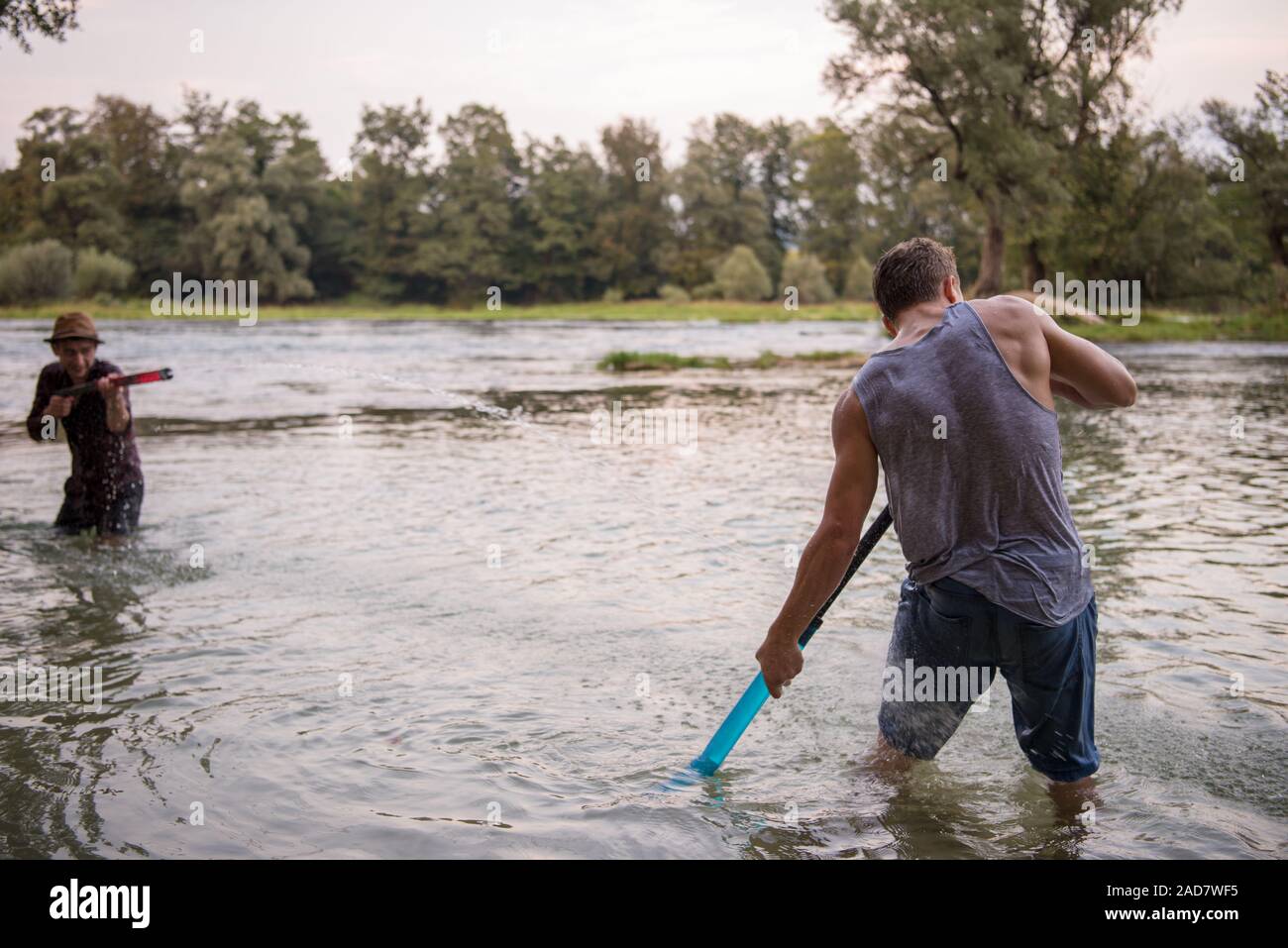 Friends playing water guns hi-res stock photography and images - Alamy