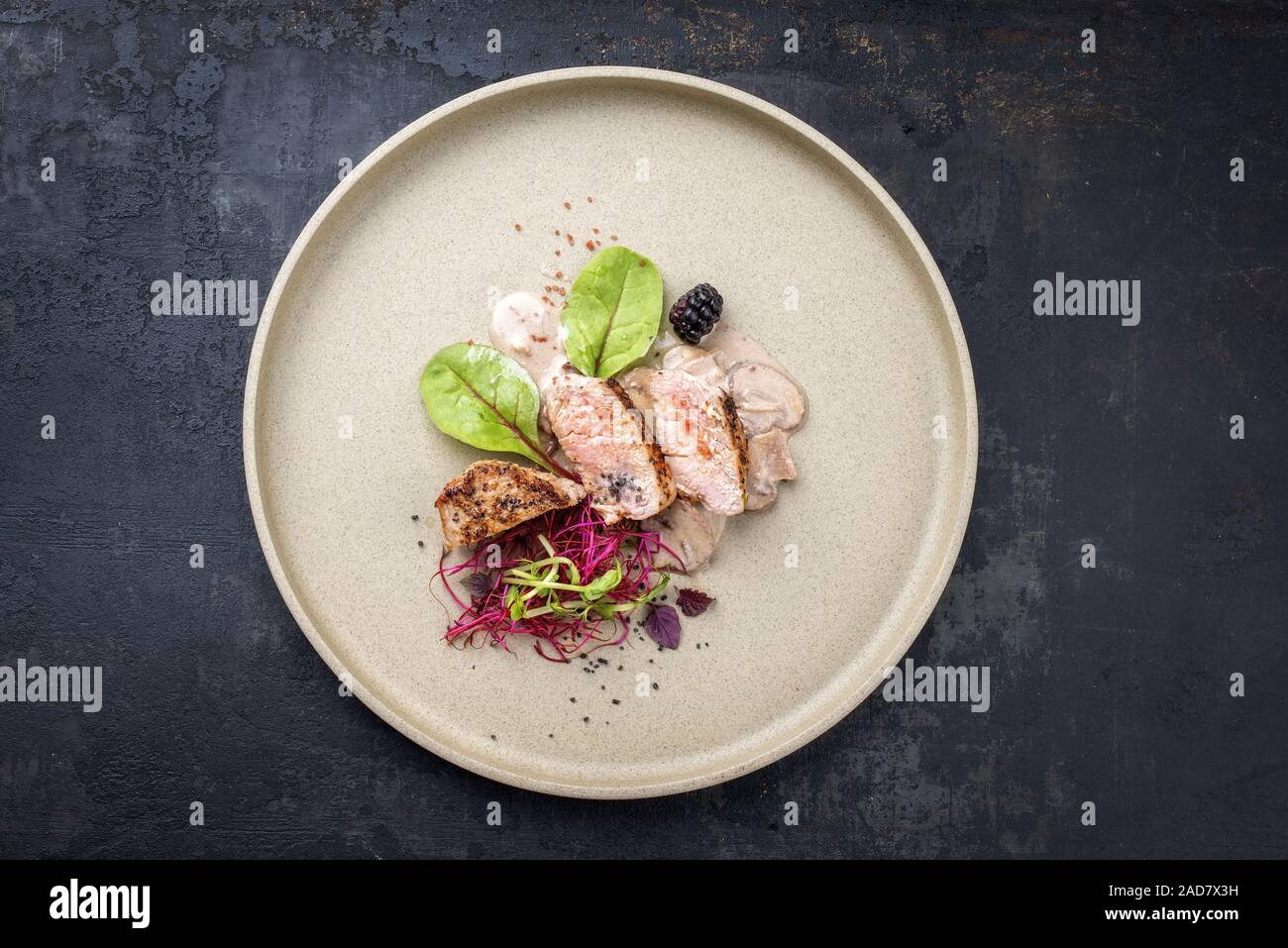 Fried pork fillet with salad and fruits as top view on a plate with ...