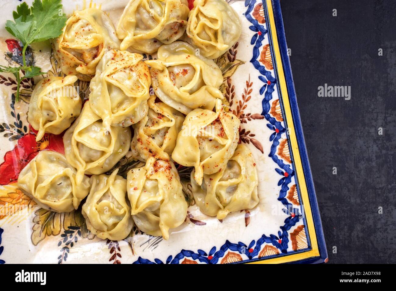 Traditional Kazakh manti steamed with mincemeat as top view on a plate ...