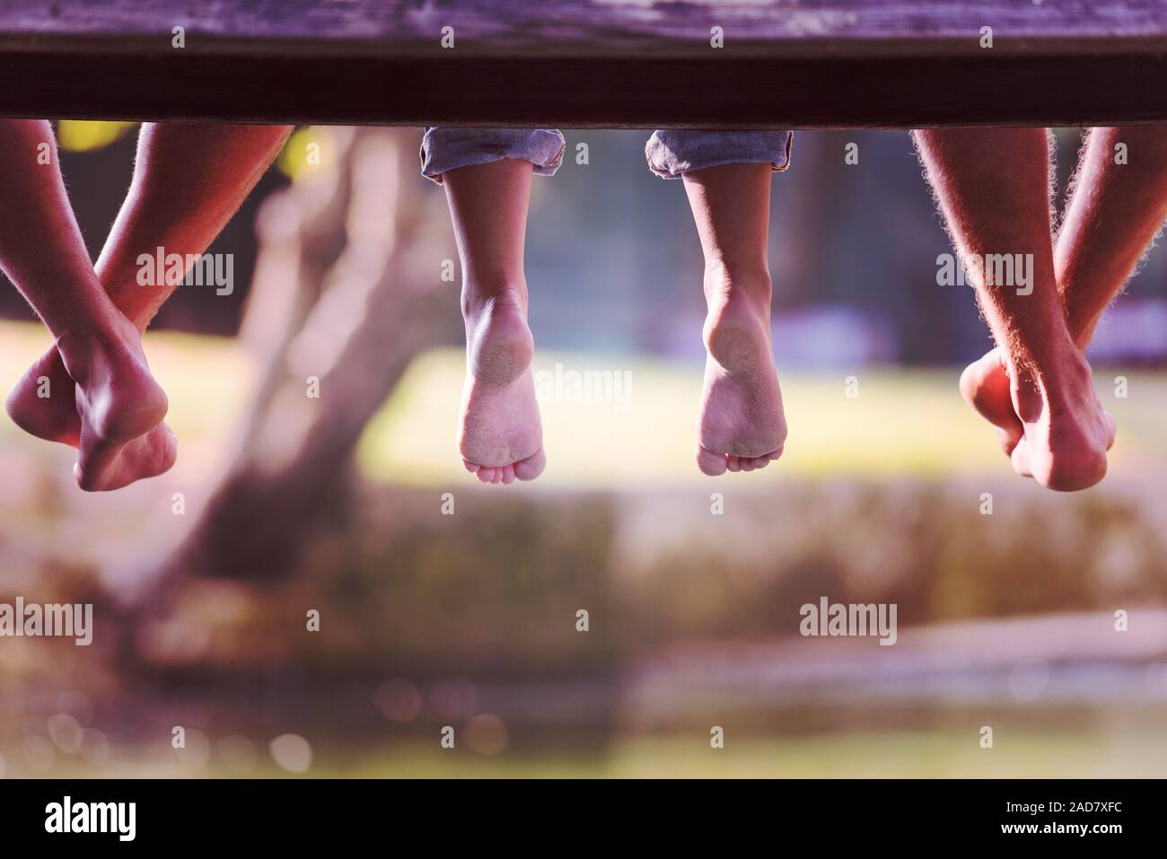 people sitting at wooden bridge Stock Photo - Alamy