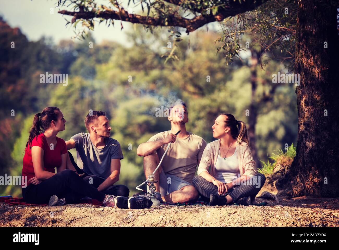 Group people smoking shisha talking hi-res stock photography and images ...