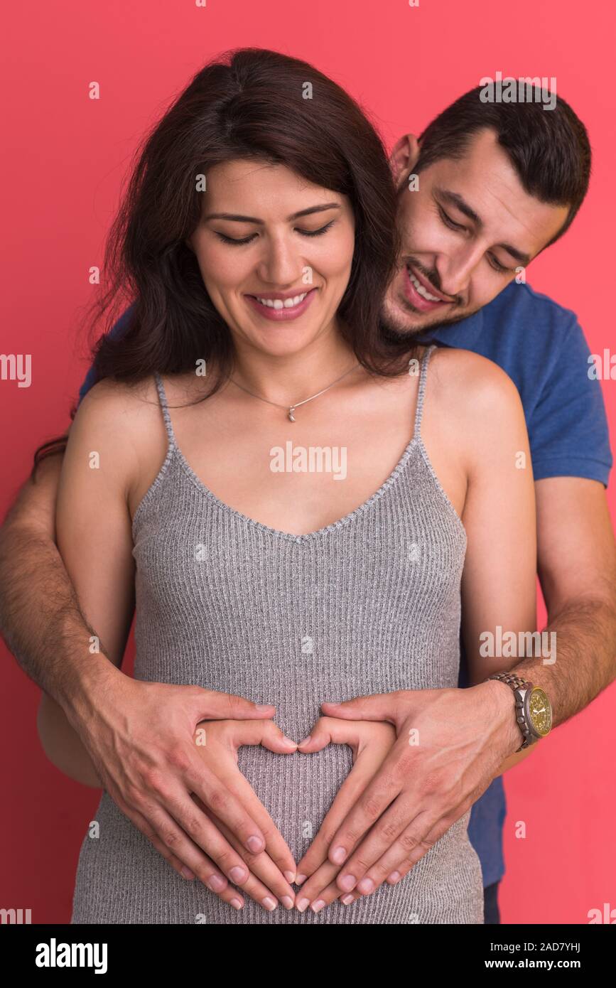 pregnant couple showing heart with their hands Stock Photo - Alamy