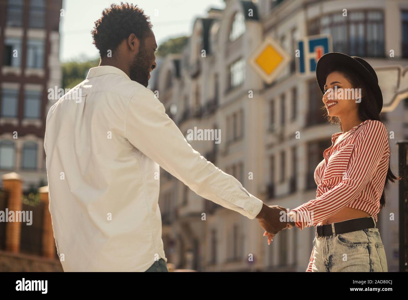 Romantic people holding hands and looking at each other Stock Photo - Alamy