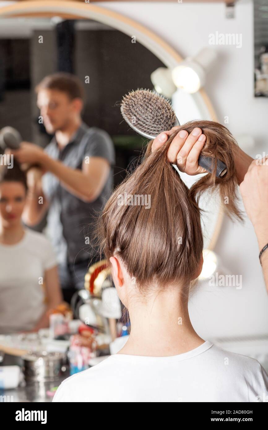 Professional hairdresser with long hair model. Professional hair care ...