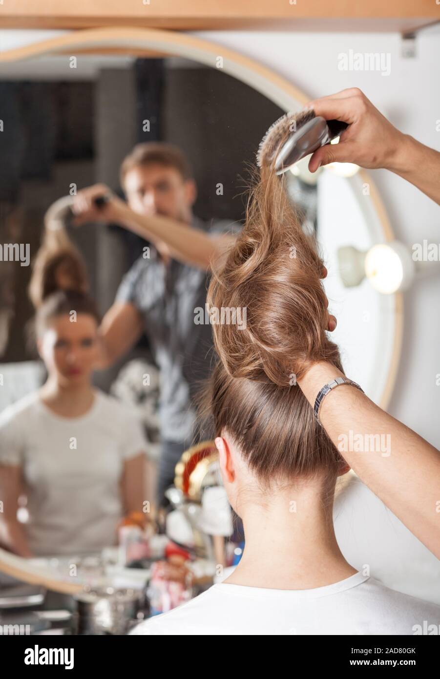 Professional hairdresser with long hair model. Professional hair care ...