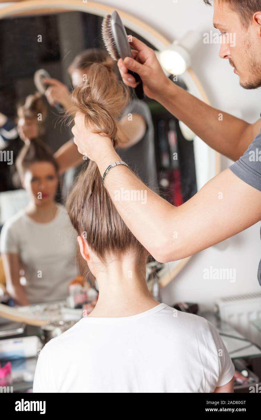 Professional hairdresser with long hair model. Professional hair care ...