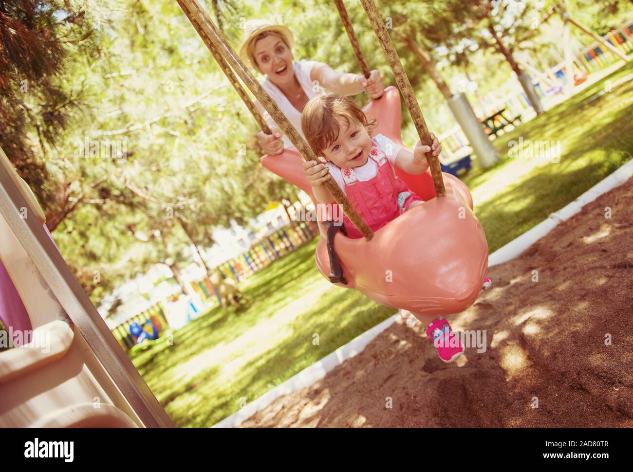 mother and daughter swinging in the park Stock Photo - Alamy