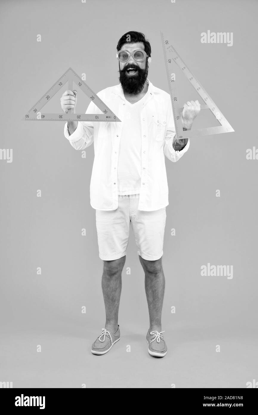 Measuring angles at geometry. Geometry teacher holding triangles for ...