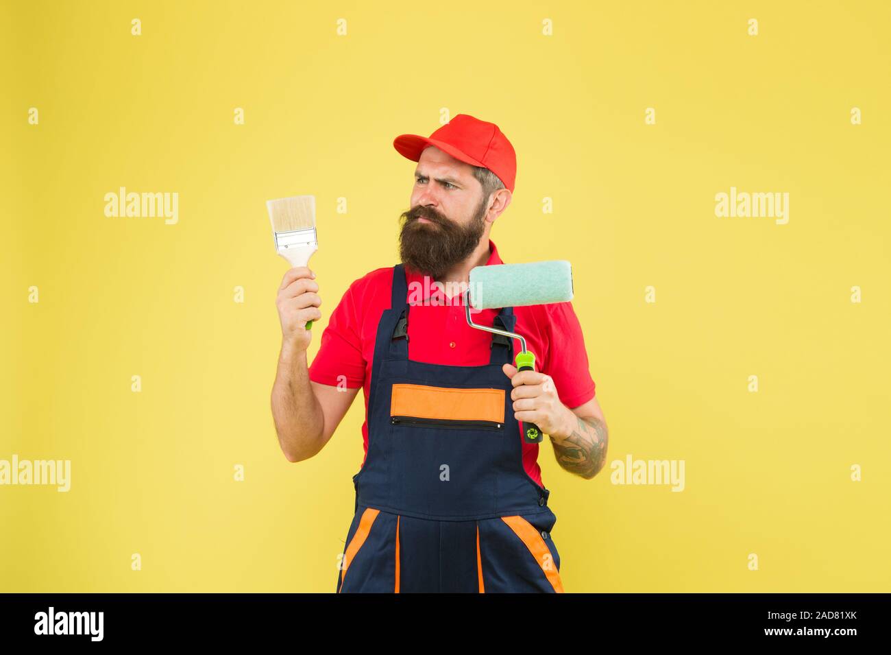 Pick tools. Painting tool. Brush roller painter. Man bearded laborer ...
