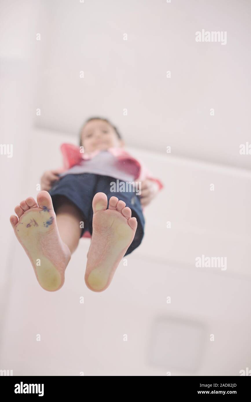 little boy standing on transparent glass floor Stock Photo - Alamy