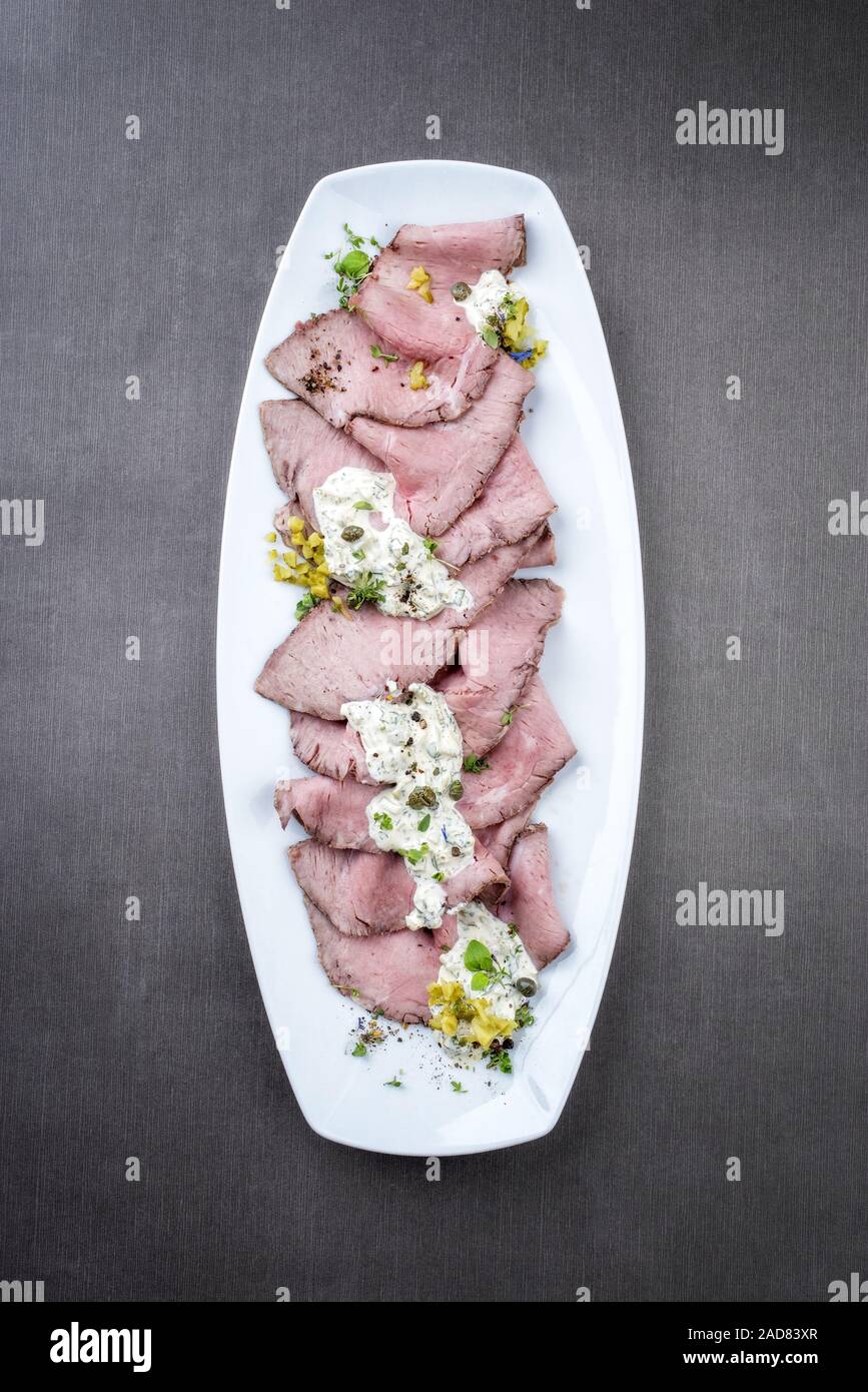 Traditional lunch meat with sliced cold cuts roast beef and remoulade ...