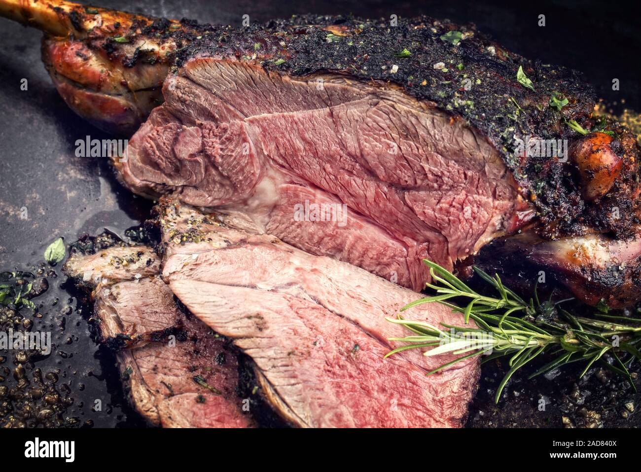 Traditional barbecue leg of lamb with spice and herb as top view on a ...