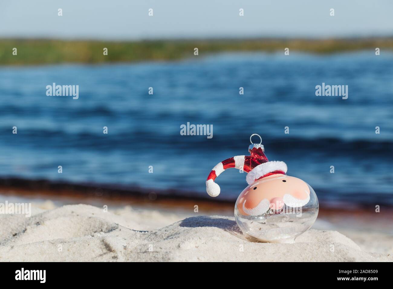Christmas in Florida concept, Santa ornament on white sand beach at ...
