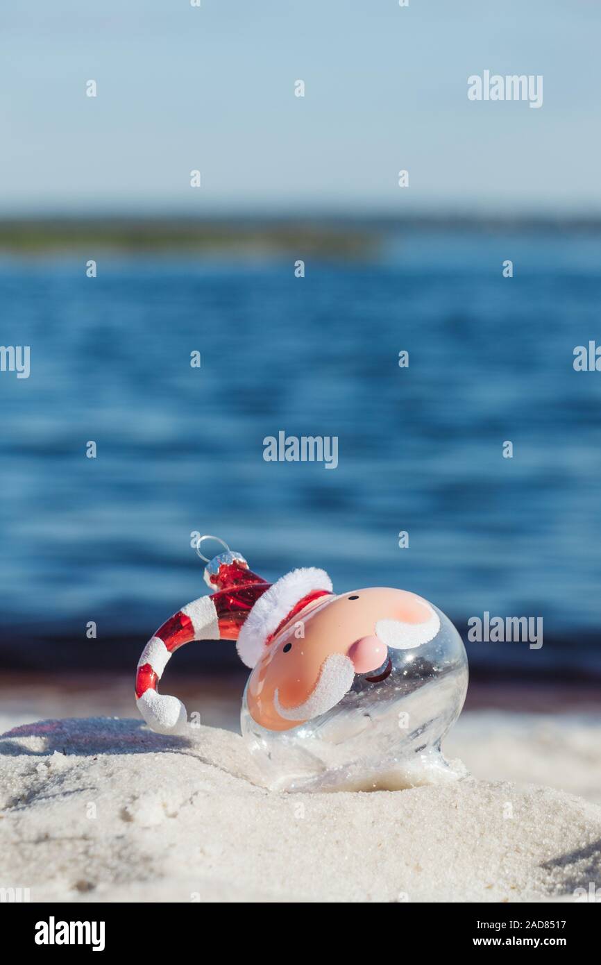 Christmas in Florida concept, santa ornament on a white sand beach at ...