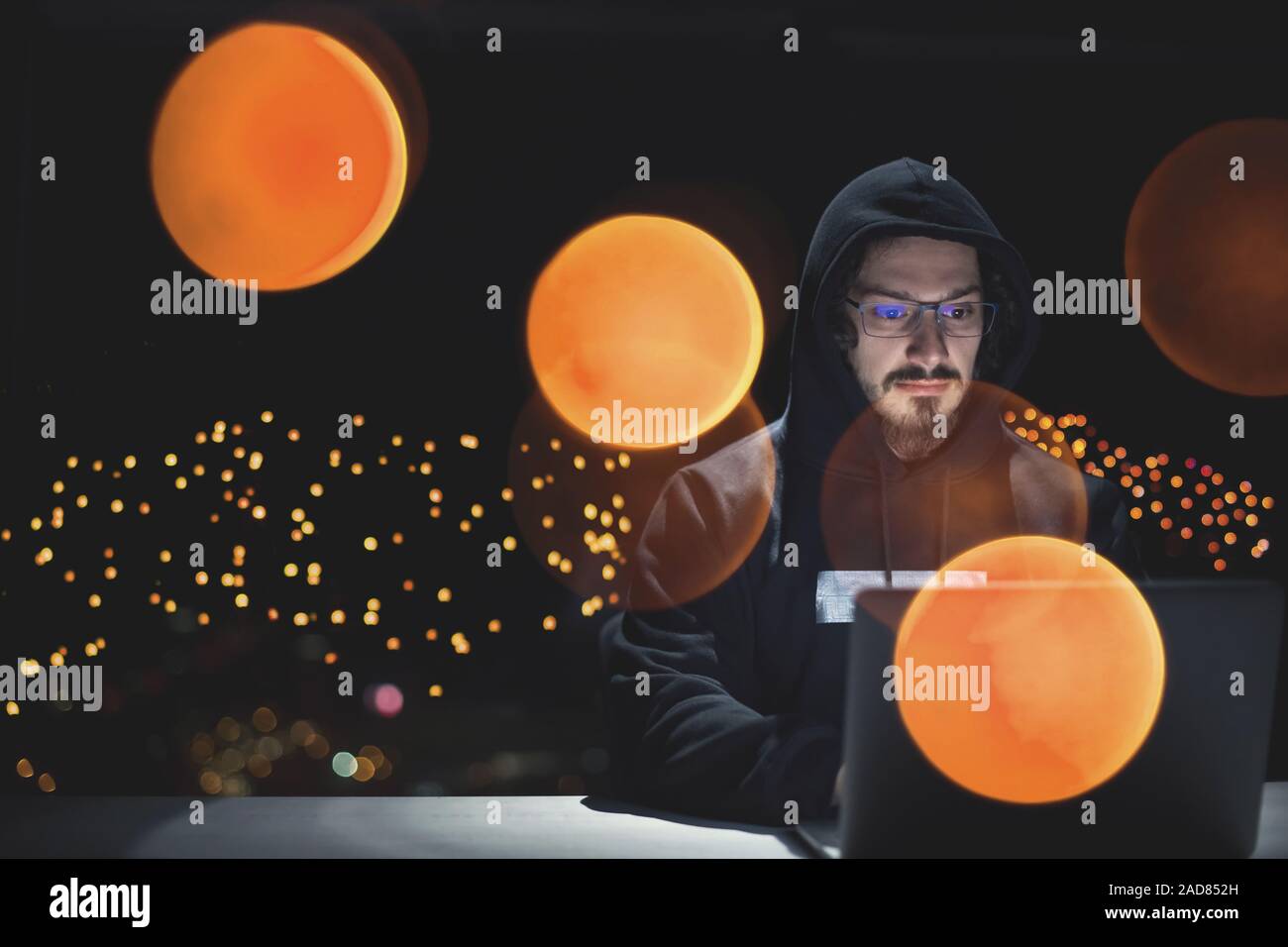 hacker using laptop computer while working in dark office Stock Photo ...